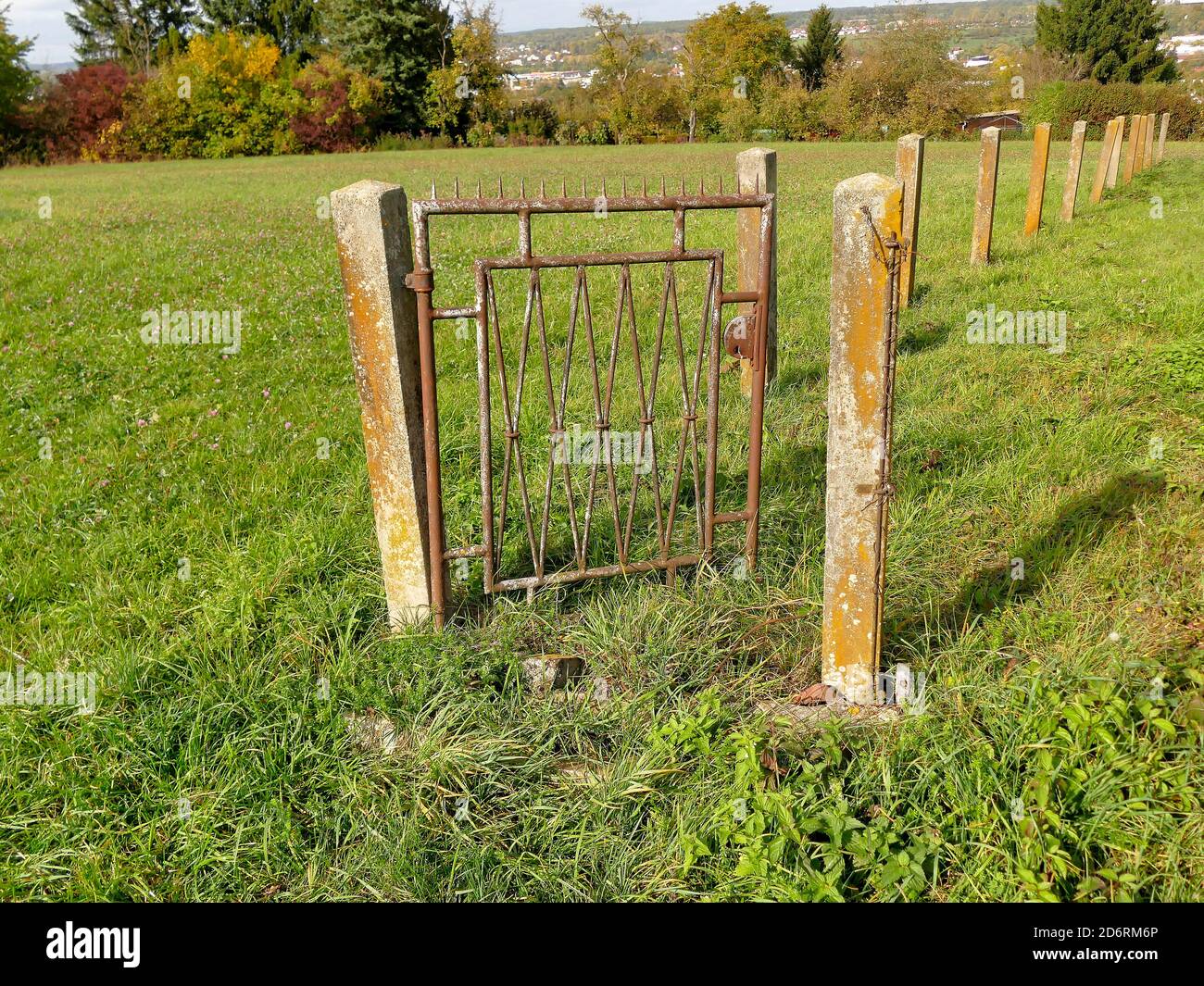 old rusty garden gate at an open garden without fence Stock Photo - Alamy