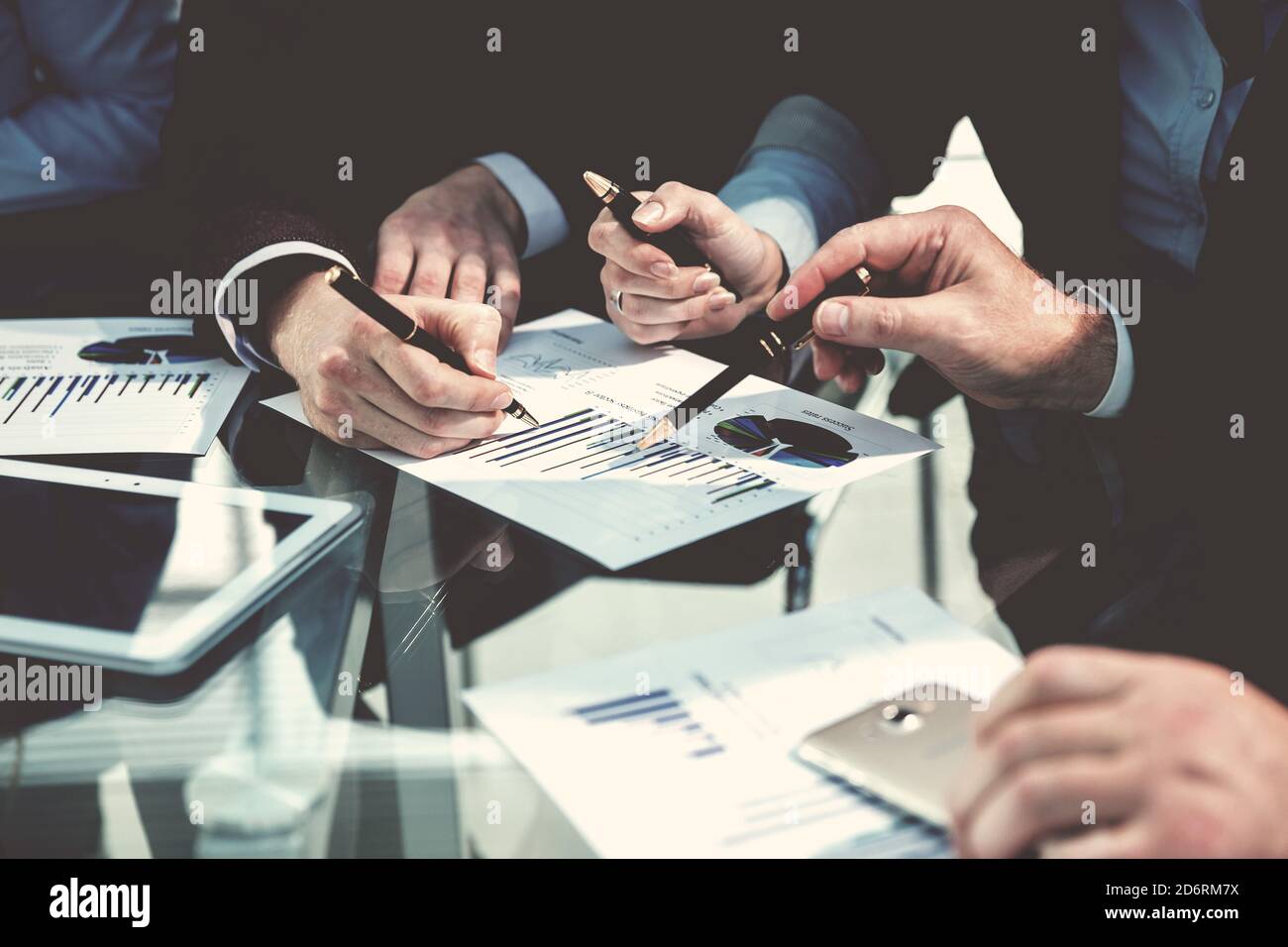 close up. business colleagues checking financial charts Stock Photo - Alamy