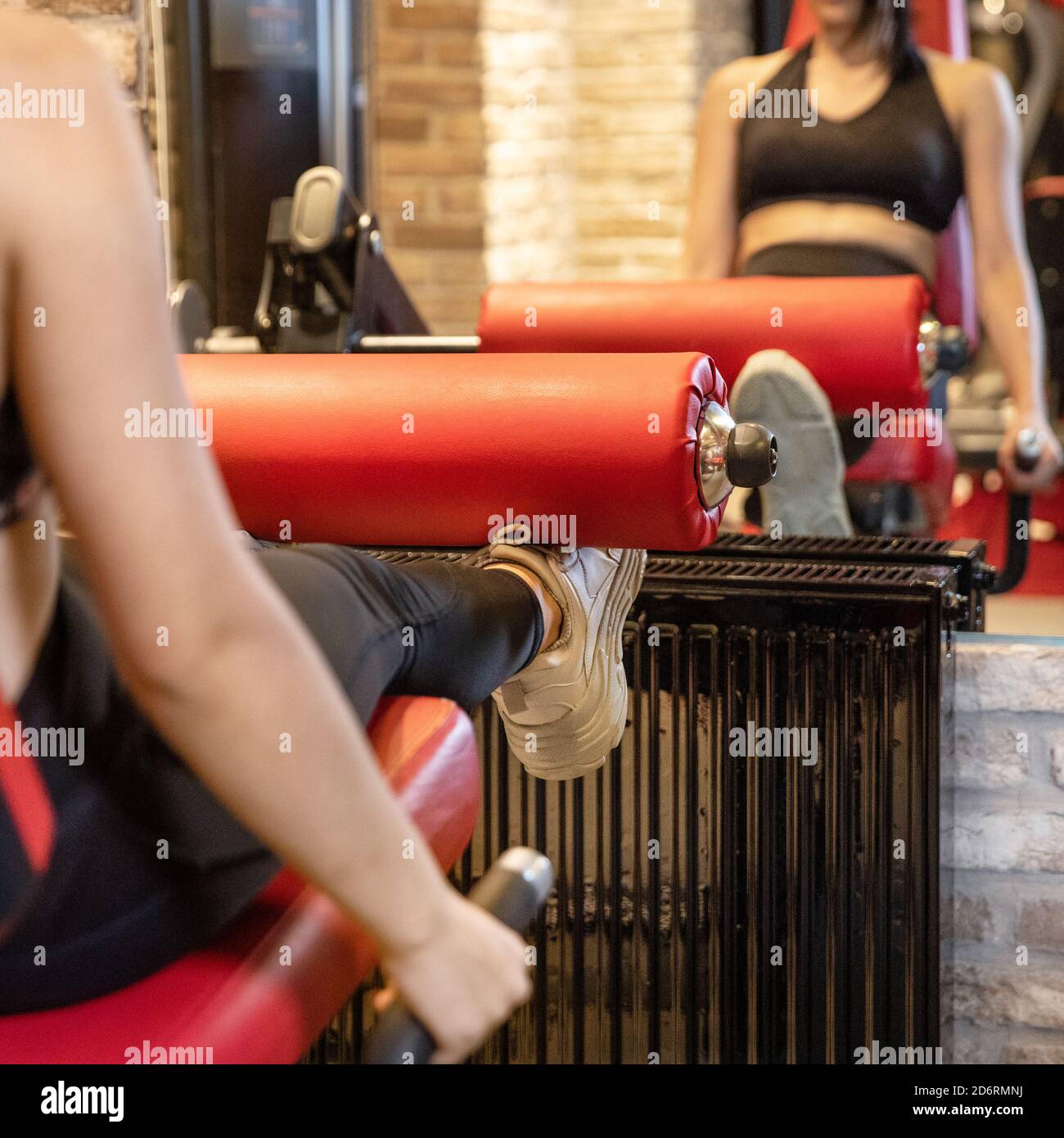 Fit young woman doing leg presses in the gym Stock Photo - Alamy