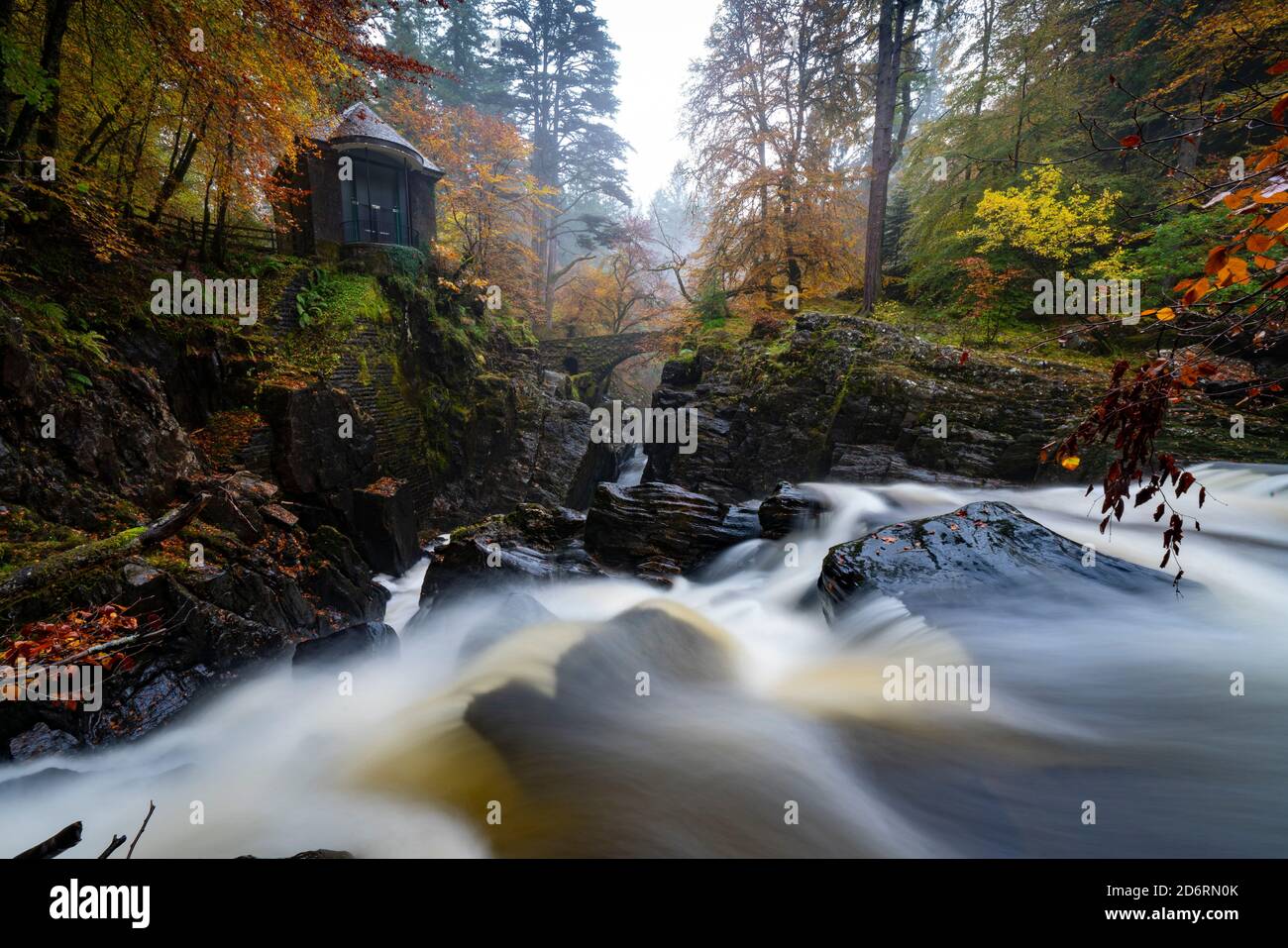 Autumn view of Ossian’s Hall overlooking cascade of Black Linn Falls on ...