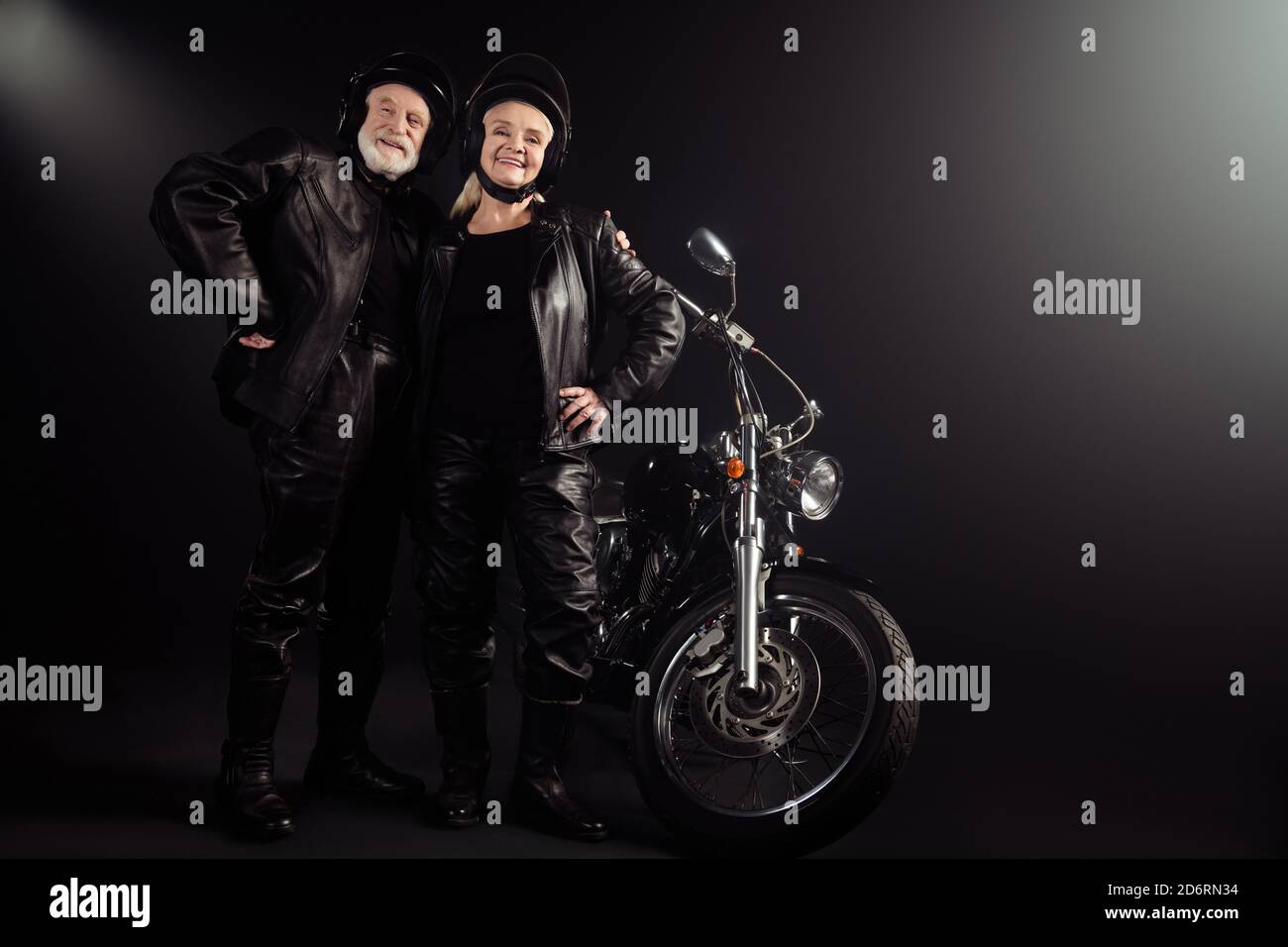Full length photo of old cool woman man biker couple hug embrace ready ...