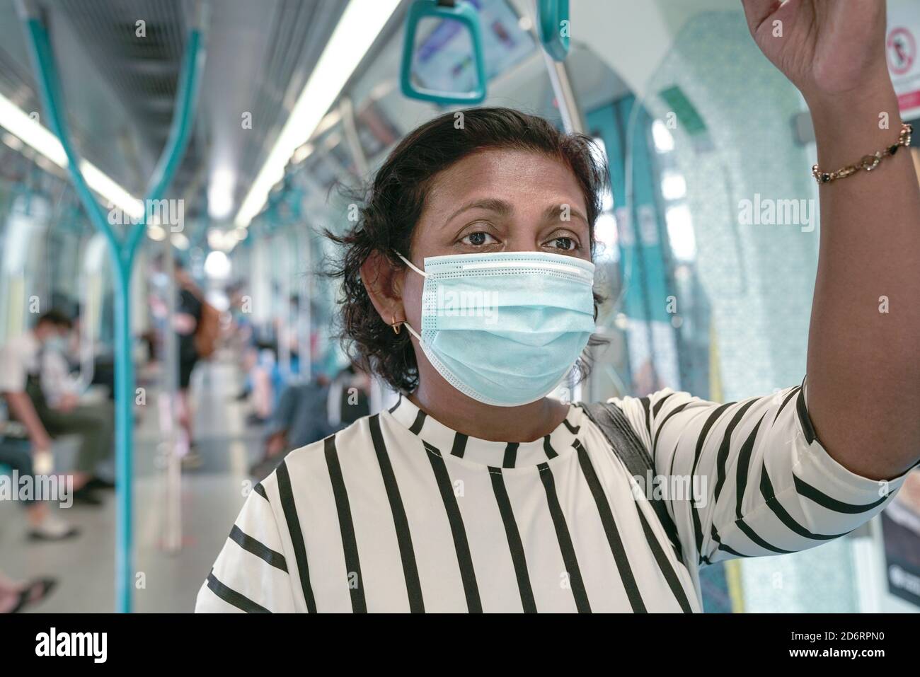 Woman commuter wearing face mask inside train. Travel during pandemic ...