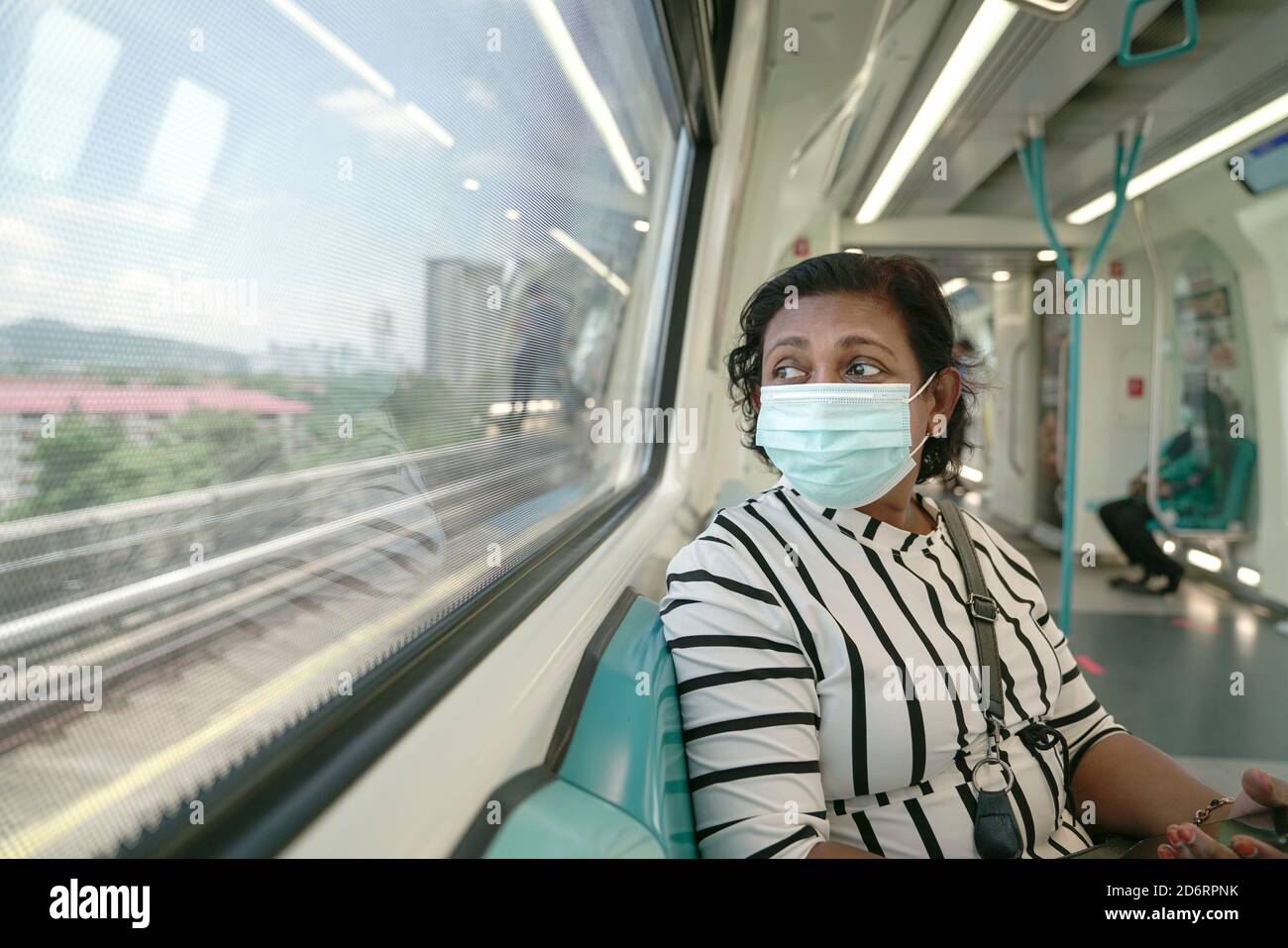 Woman commuter wearing face mask inside subway train. Travel new normal ...