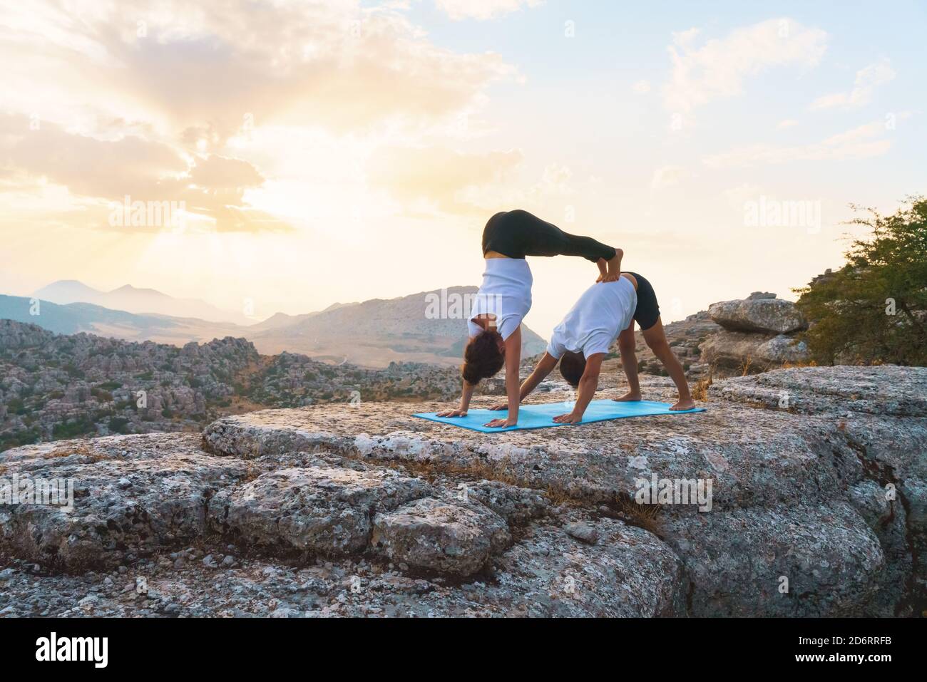 Full body of unrecognizable couple practicing acro yoga and man doing ...