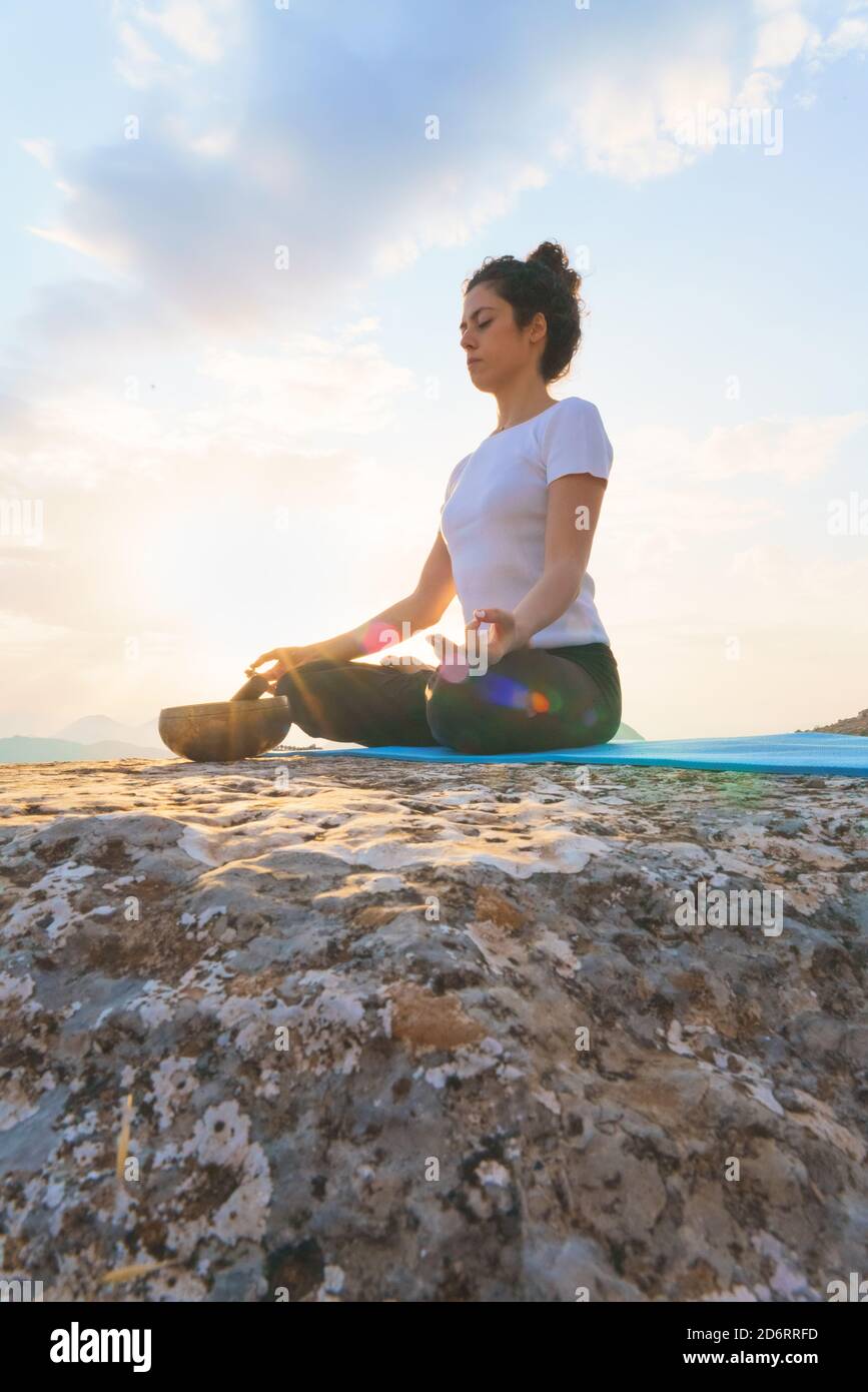 From below side view of concentrated serene young female sitting in ...