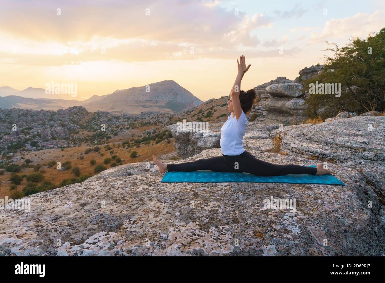 Back view of unrecognizable female performing front splits with arms ...
