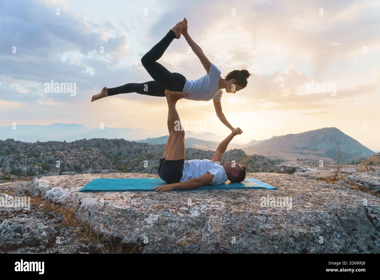 Full body side view of focused man and Woman practicing acro yoga and ...