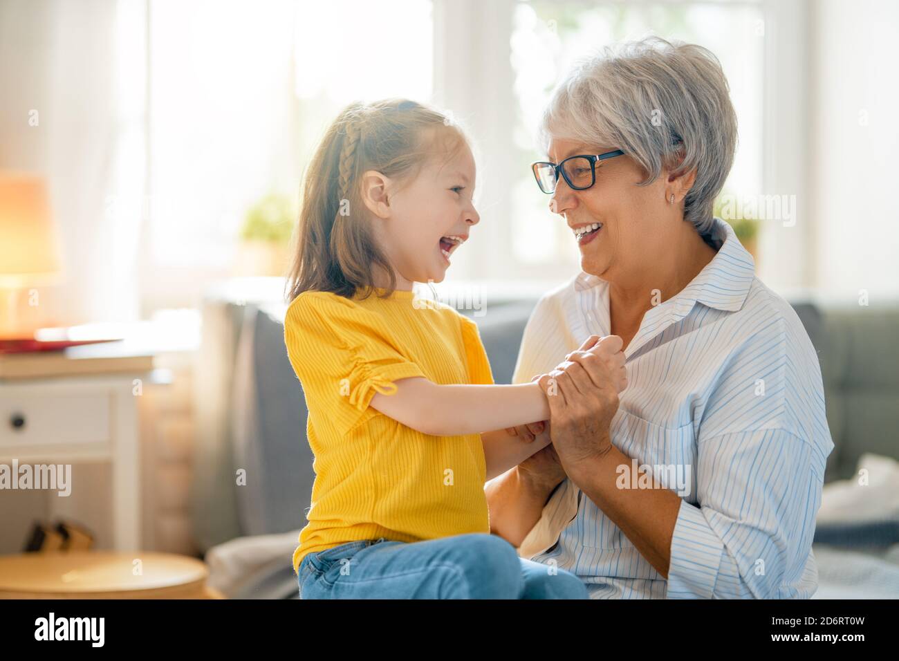 A nice girl and her grandmother enjoying sunny morning. Good time at ...