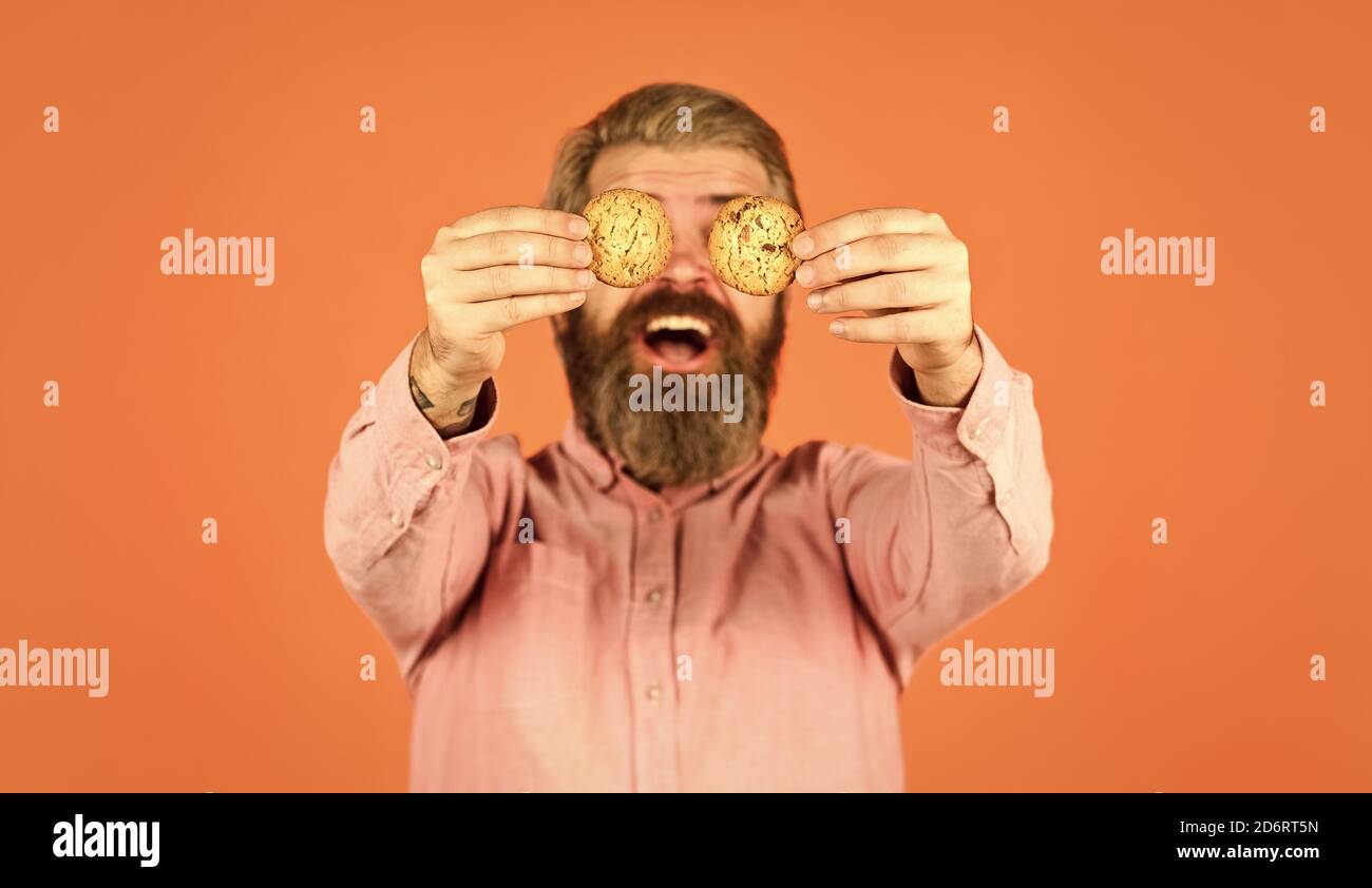 man eating chocolate chips cookie. full of calorie. concept of harmful ...