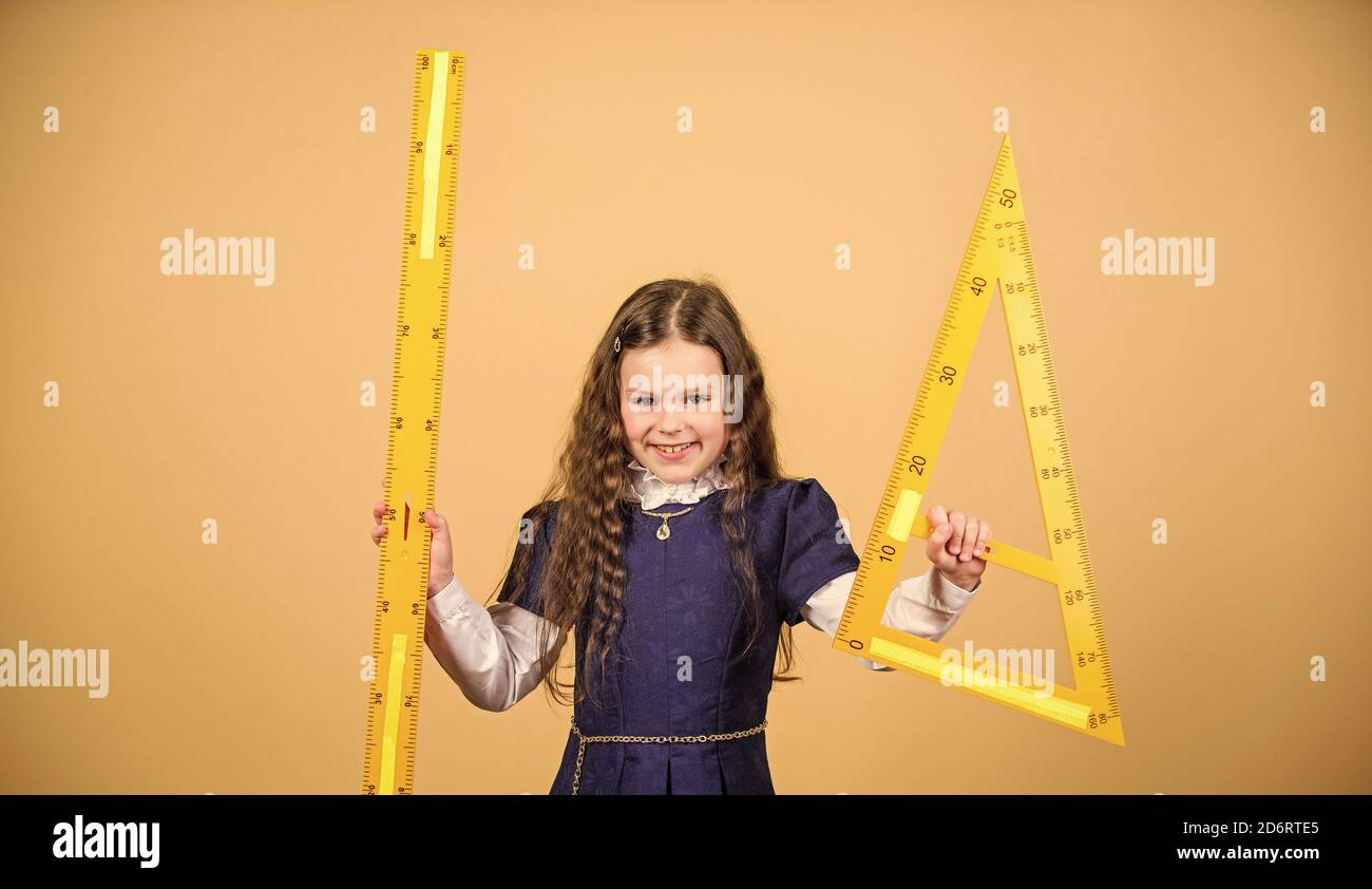 Sizing and measuring. Pupil cute girl with big ruler. School student ...
