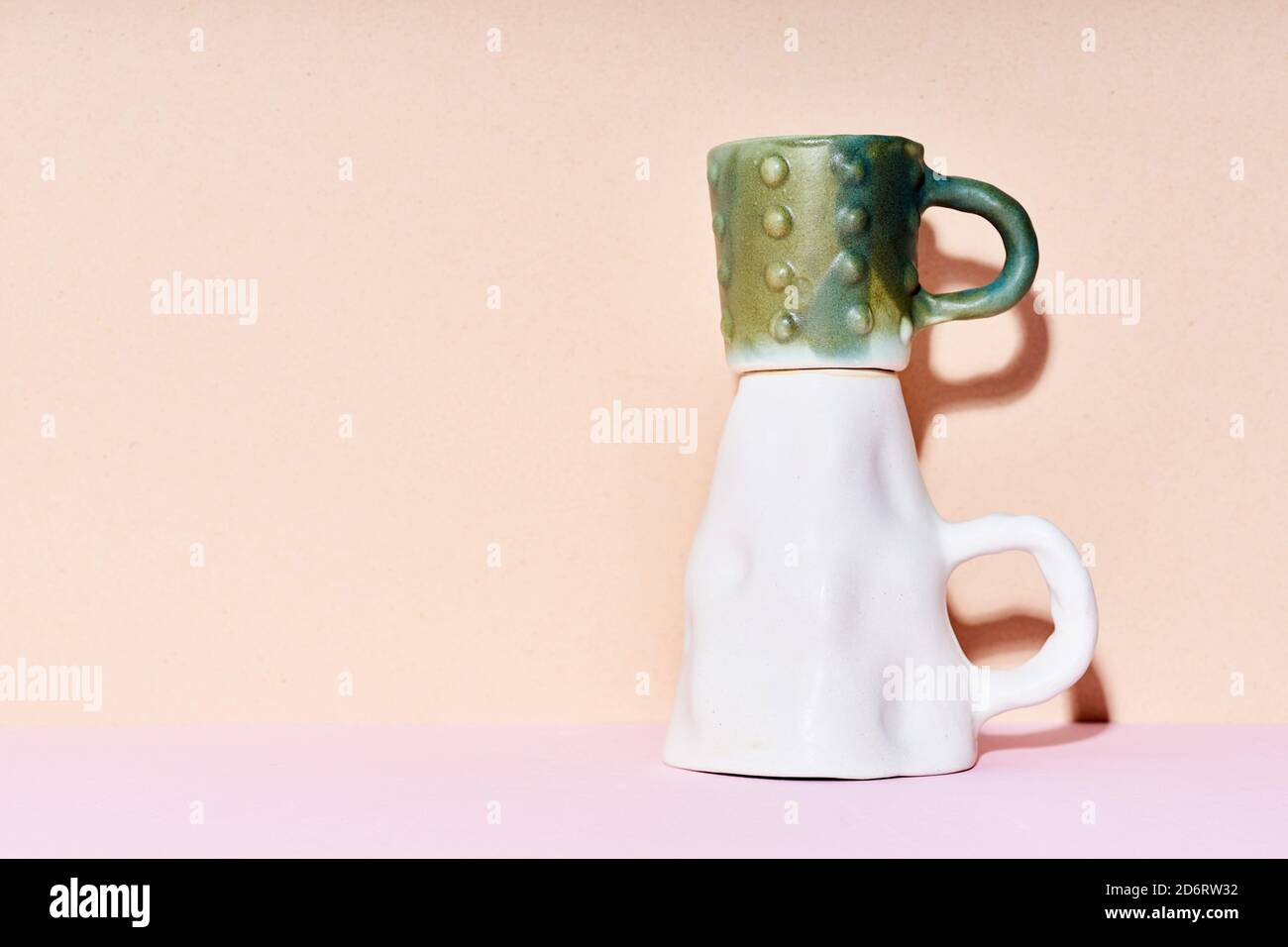 Still life of handmade ceramic mugs on bright studio background Stock ...