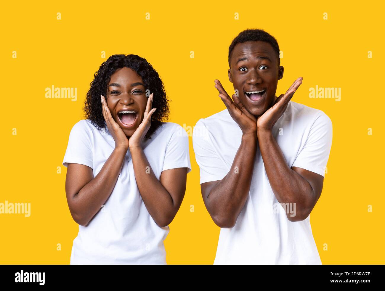 Surprised black couple screaming and touching their faces Stock Photo ...