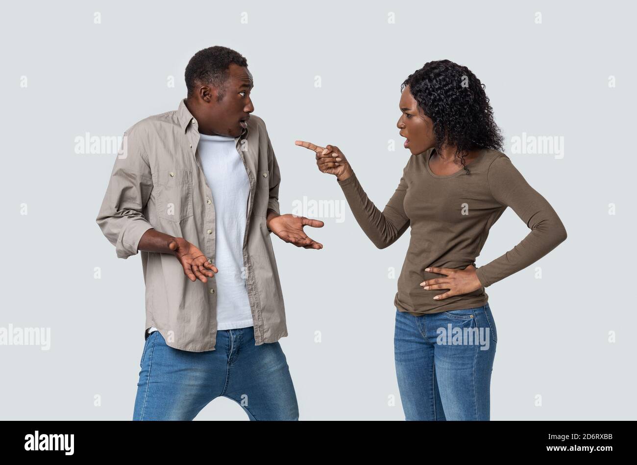 Furious african woman yelling and pointing at her boyfriend Stock Photo ...