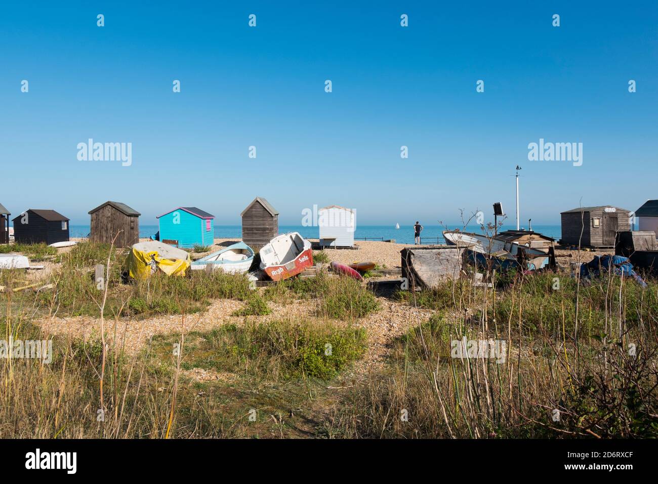 A row of beach huts across the wild flora along the beach at Kingsdown ...