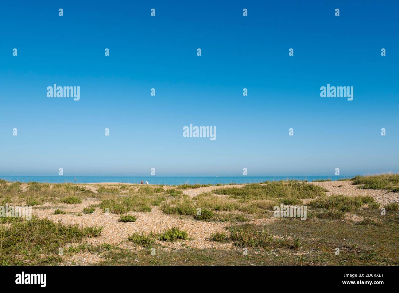 Two people sitting on the beach Kingsdown, Deal, Kent, UK Stock Photo ...