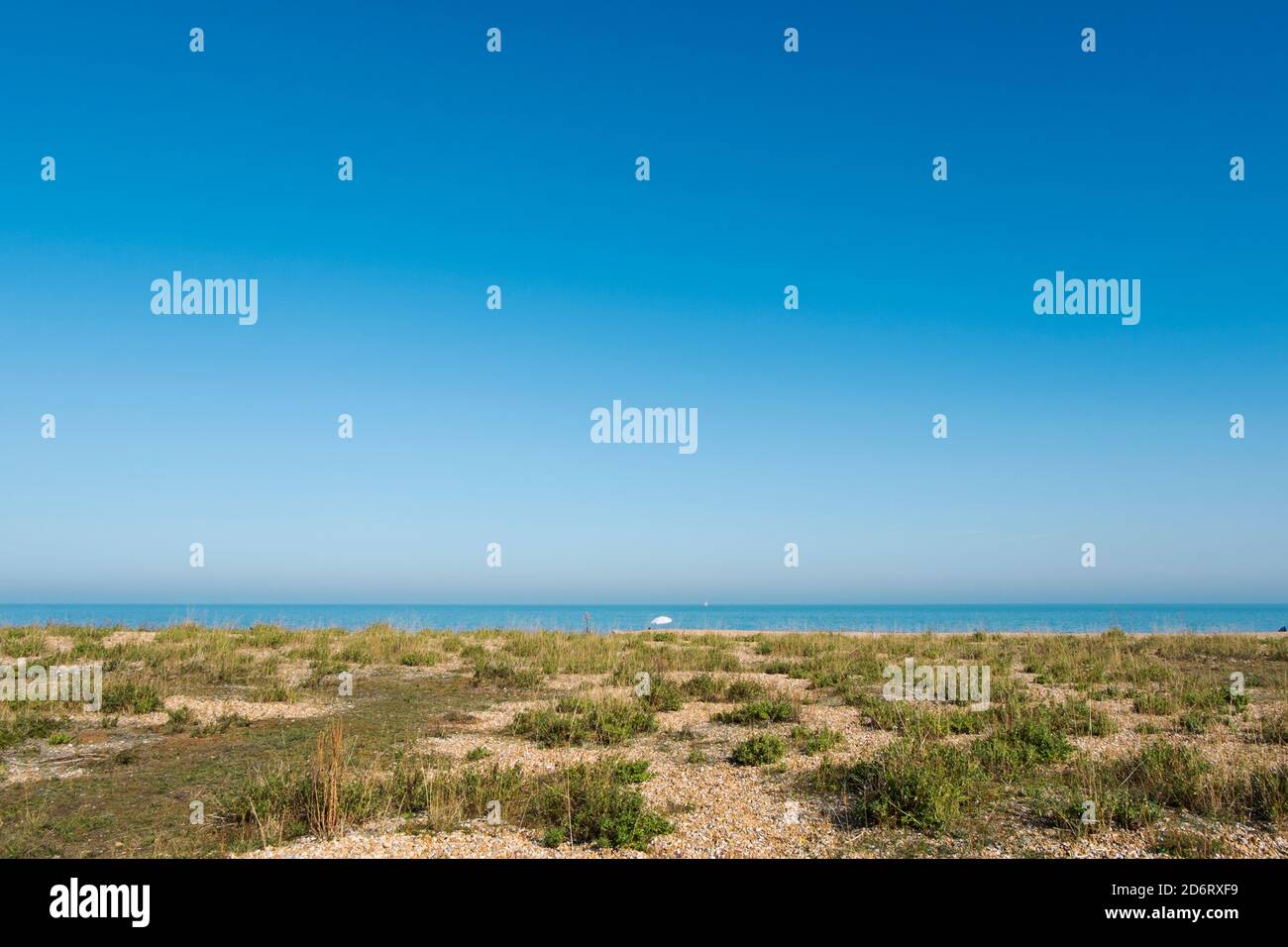 Two people sitting on the beach Kingsdown, Deal, Kent, UK Stock Photo ...