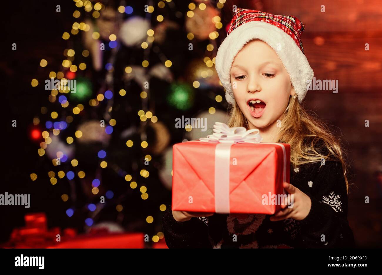 Best surprise gift ever. Adorable kid looking at gift box with surprise ...