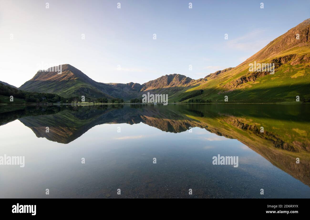 Summer early morning reflections on Buttermere in the Lake District ...