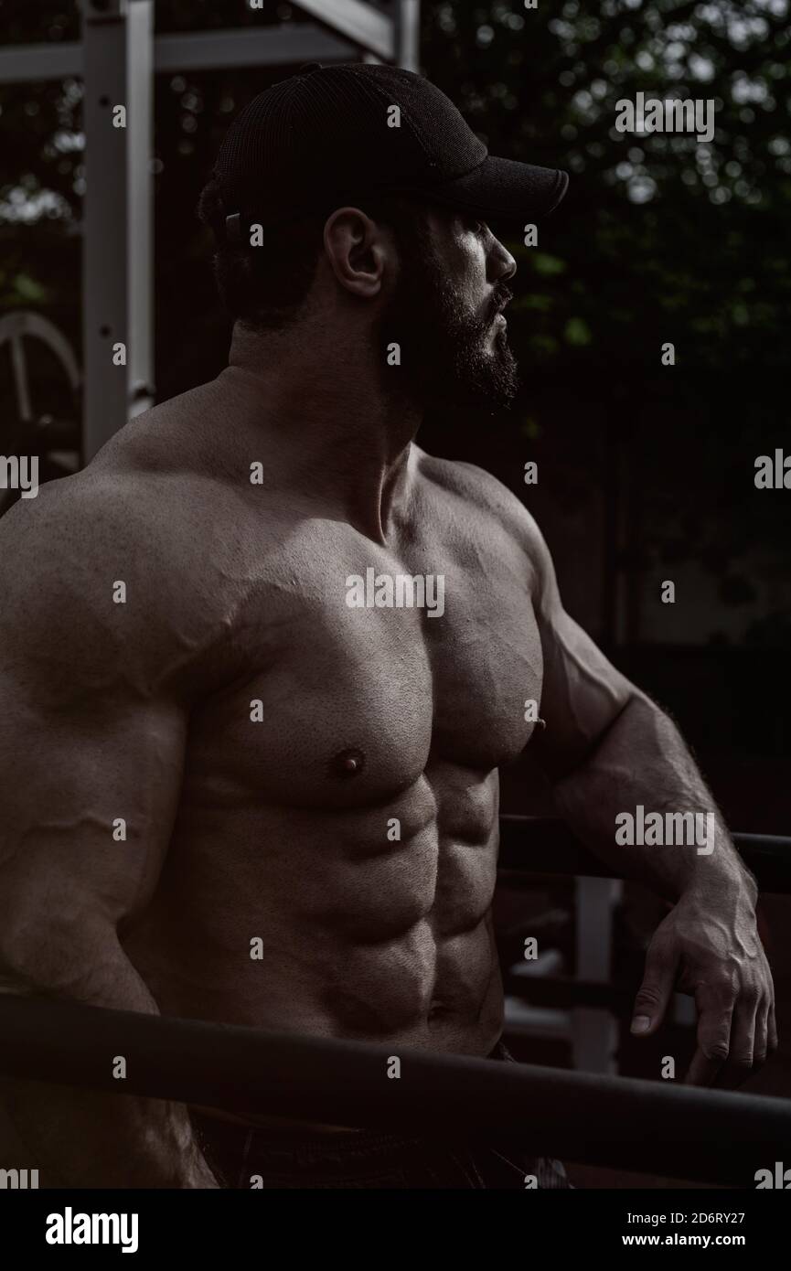 strong young male athlete with beard and perfect muscle physique body ...