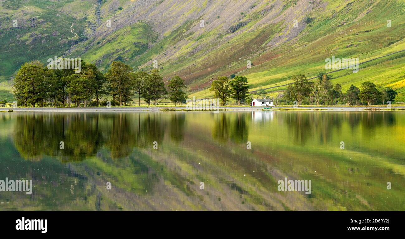 Summer early morning reflections on Buttermere in the Lake District ...