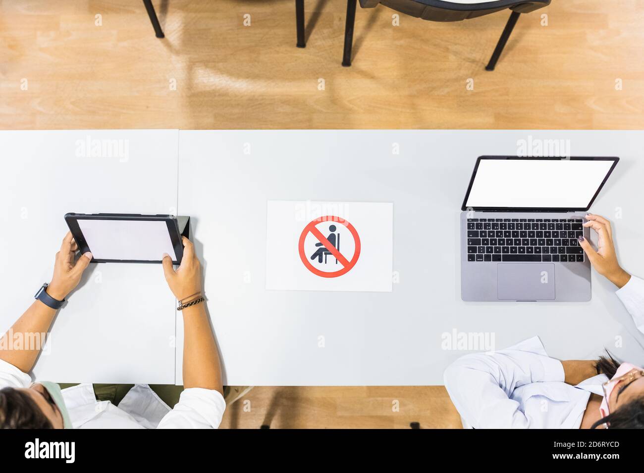 Top view of anonymous female coworkers using netbook and tablet with ...