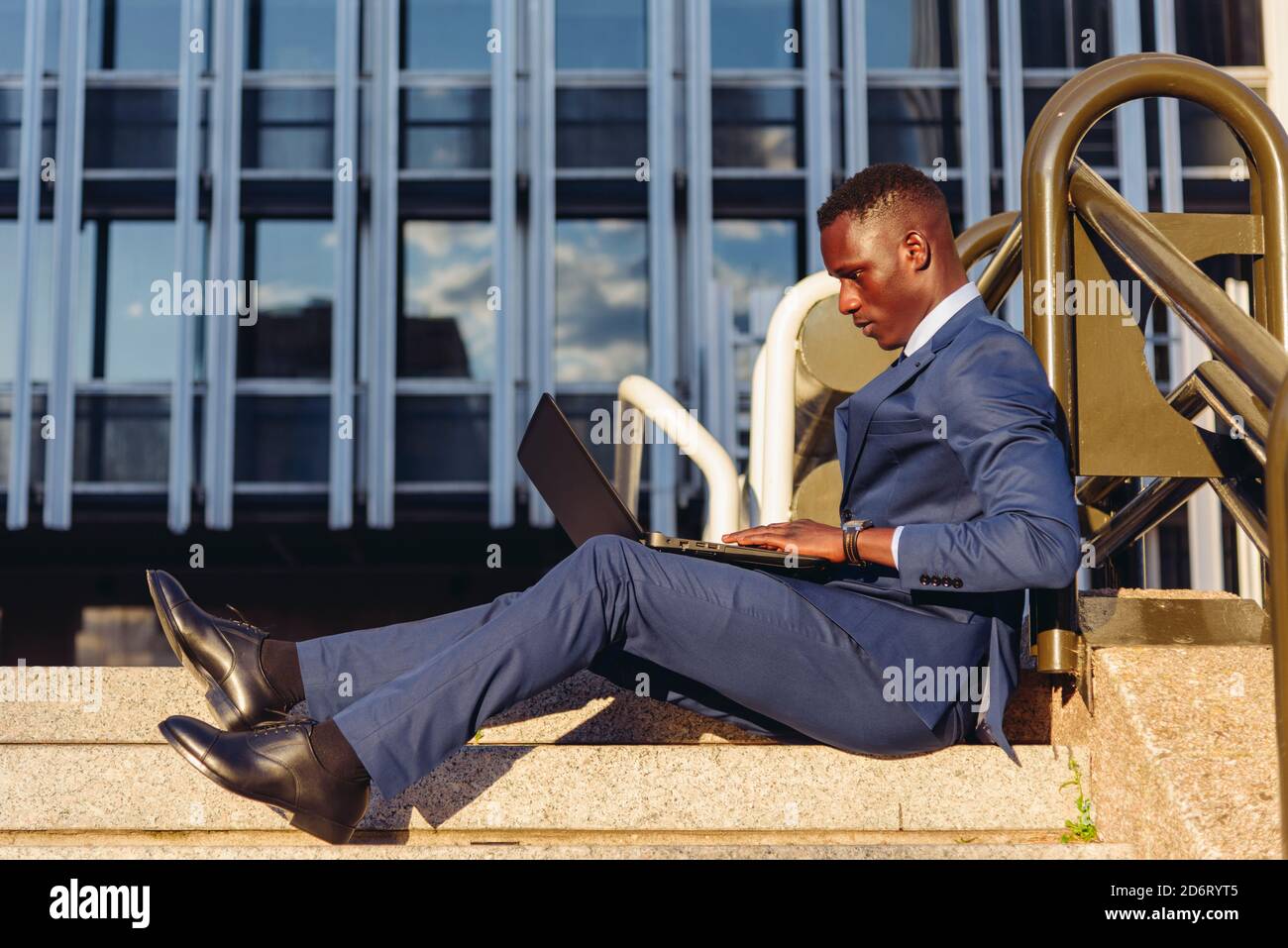 Full body side view of concentrated African American financial manager ...