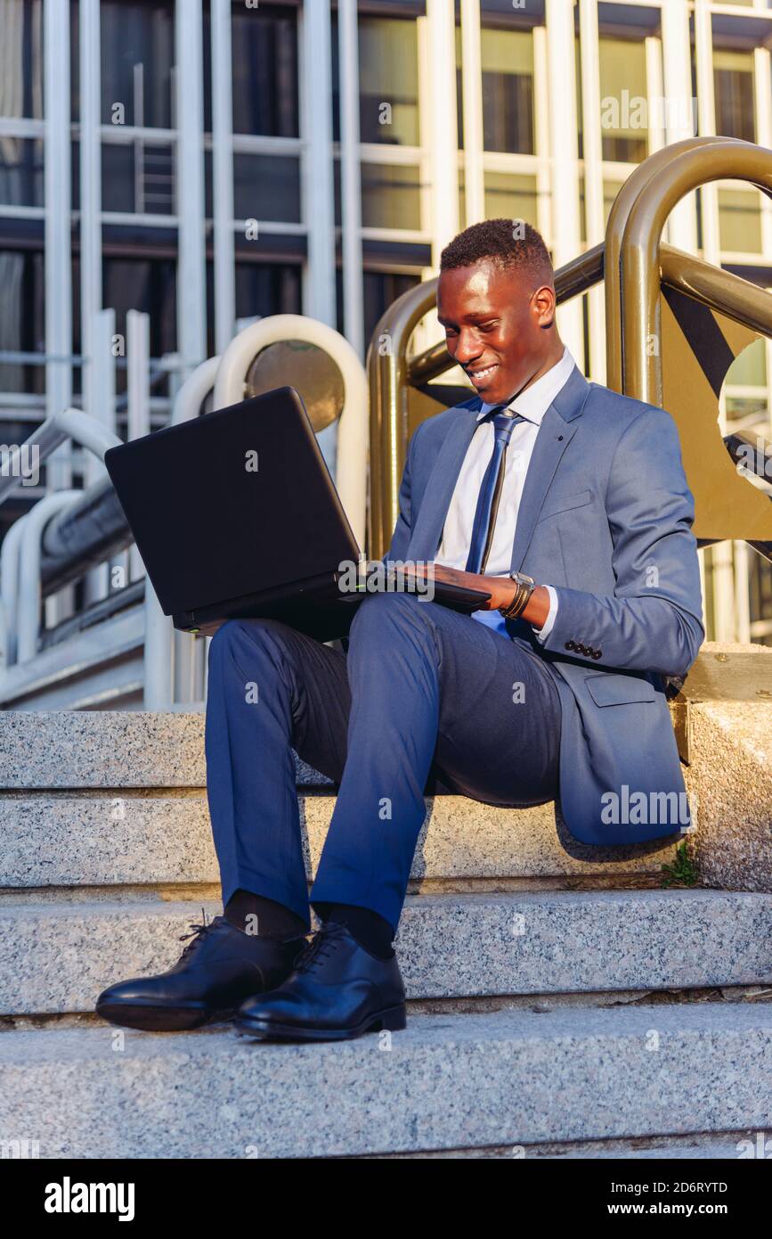 Full body side view of concentrated African American financial manager ...