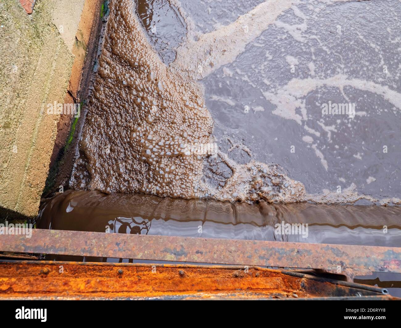 Activated bubbling wastewater on the water surface in detail. City ...