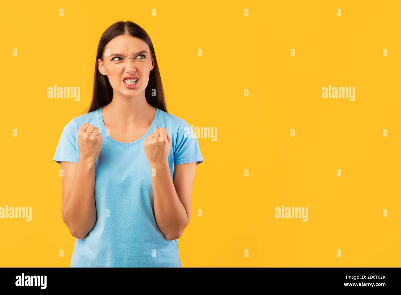Angry young woman holding hands in furious gesture Stock Photo - Alamy