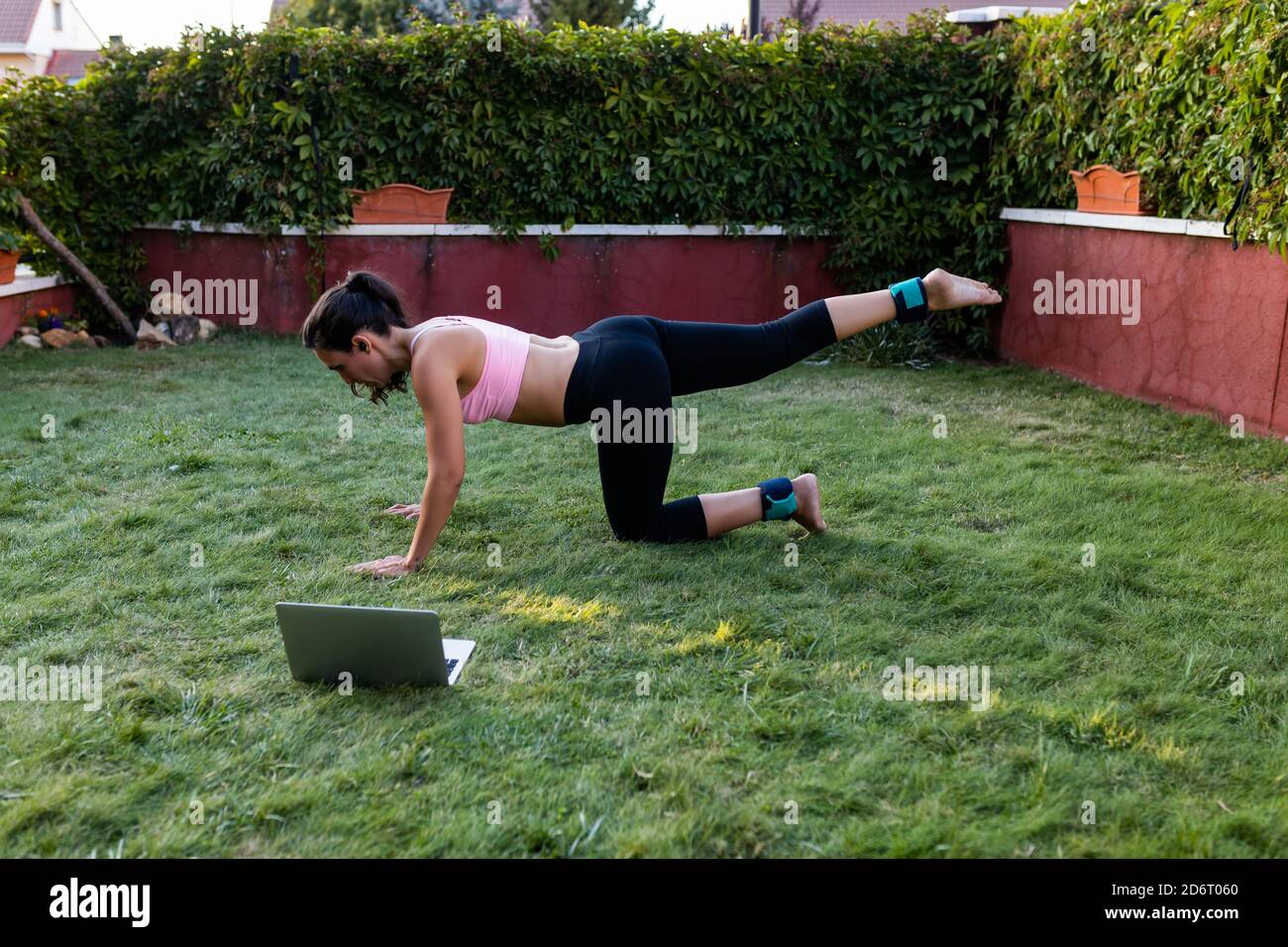 Side view of slim female athlete leaning on hand and knees while doing ...