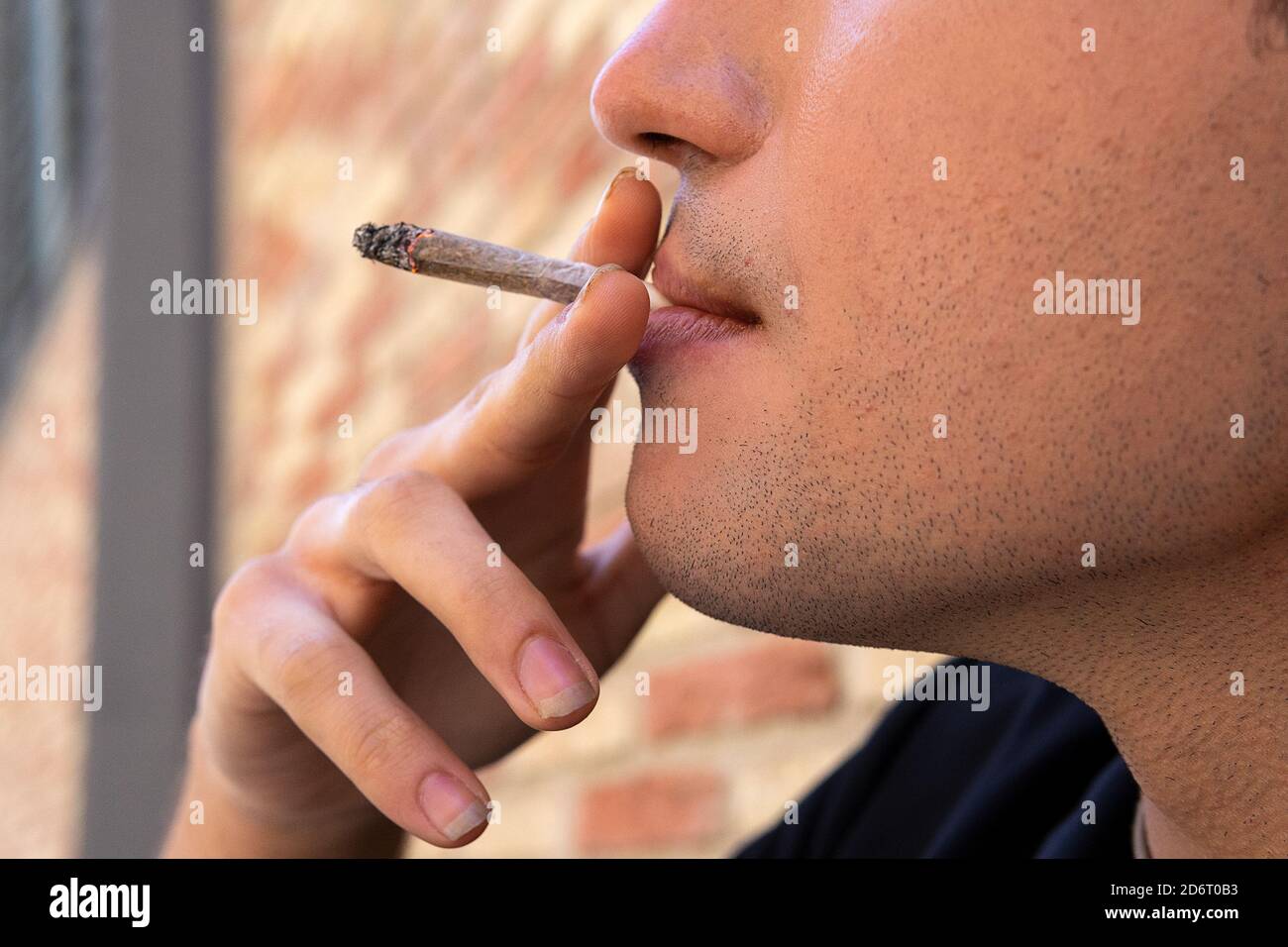 Side view of cropped unrecognizable young trendy concentrated male ...