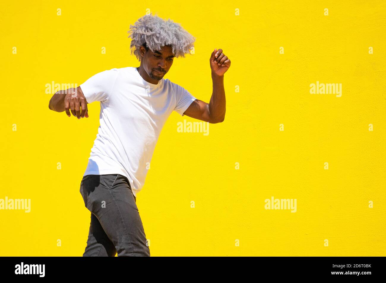 Black dancer dancing on a yellow background. Dance and music concept ...