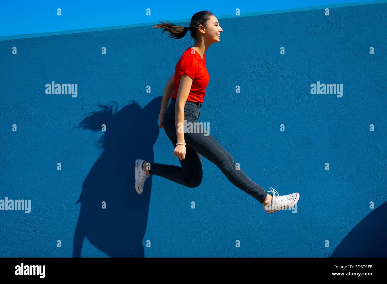 Woman in red dress jump hi-res stock photography and images - Alamy