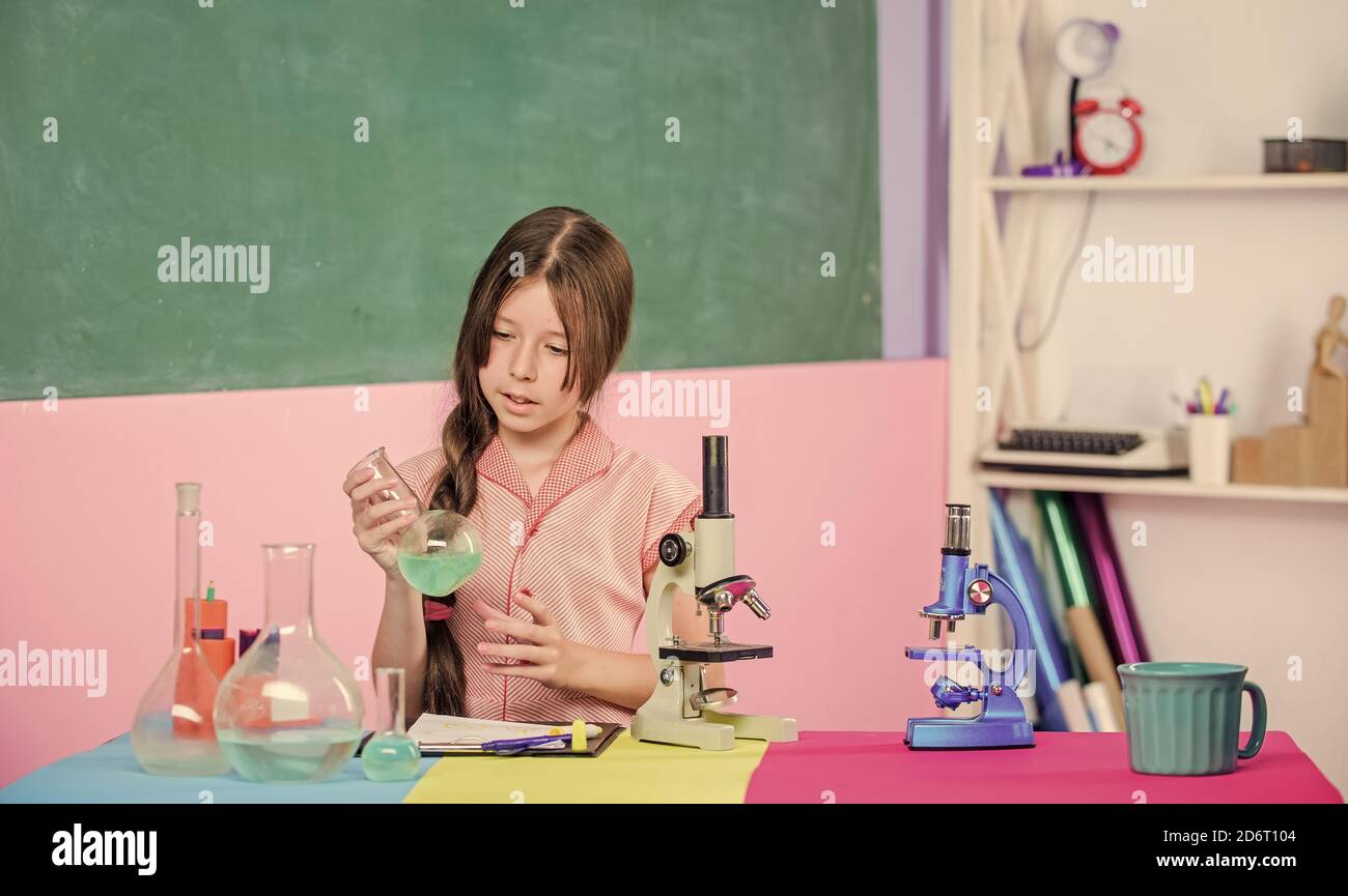 Scientific experiment. small girl with lab flask. back to school ...