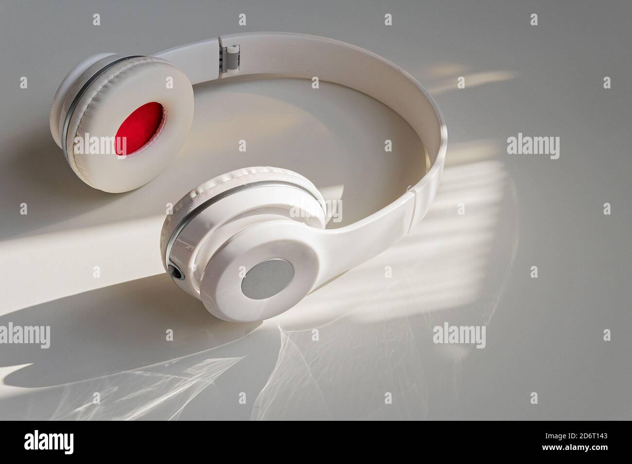 High angle of contemporary wireless headphones placed on white table in ...