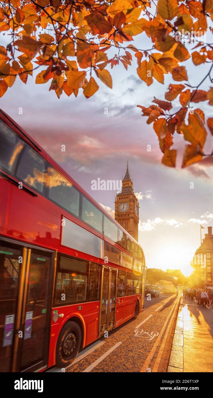 Big Ben against colorful sunset with red bus during autumn in London ...