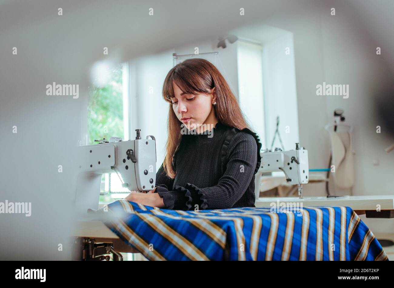 Seamstress working on the sewing machine Stock Photo - Alamy