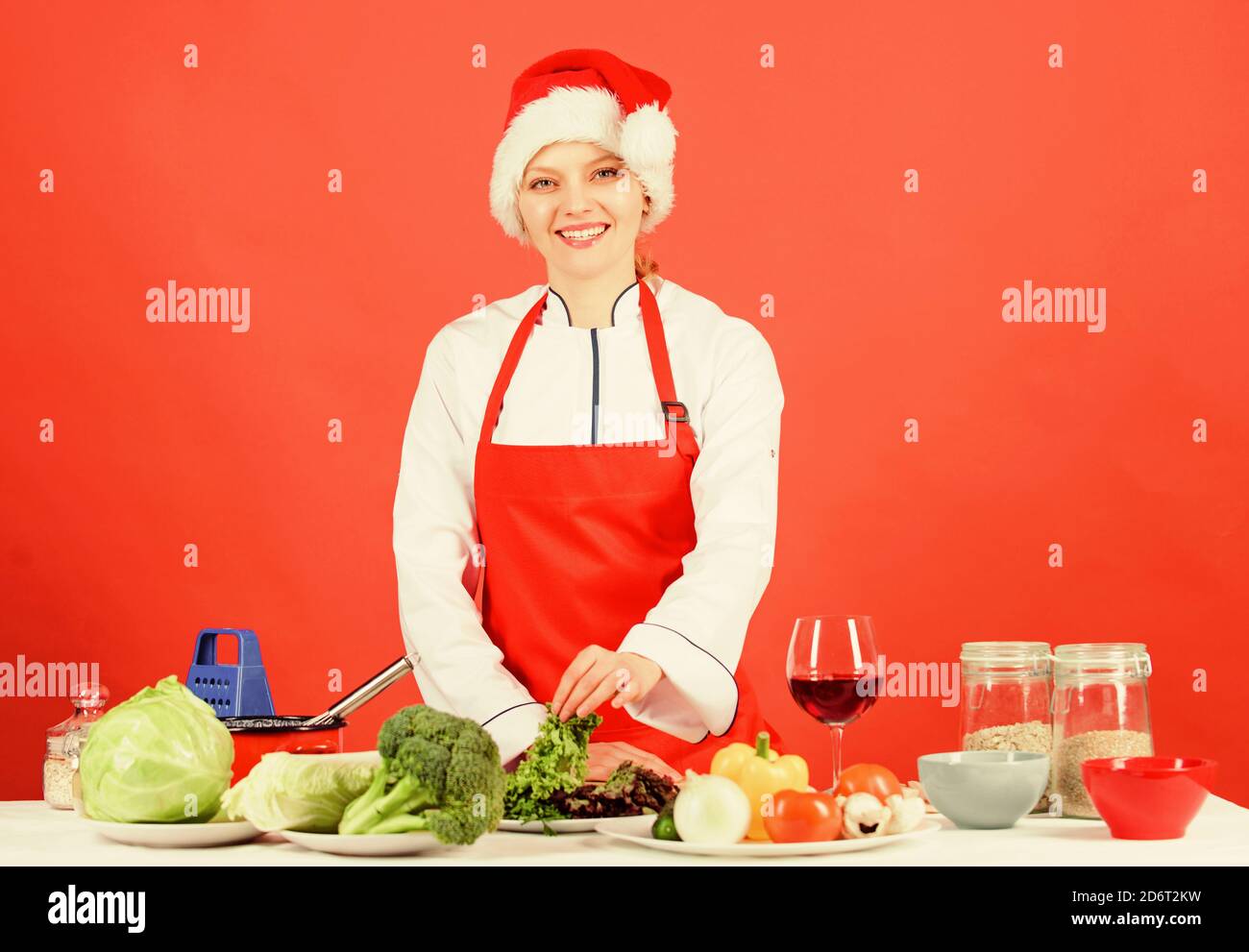 Woman chef cooking christmas dinner wear santa hat. Festive menu ...