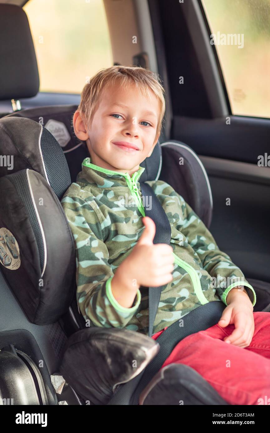 Little boy sitting on a car seat buckled up in the car. Children's Car ...