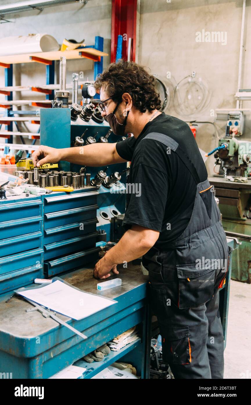 Side view busy adult male engineer wearing uniform and protective face ...