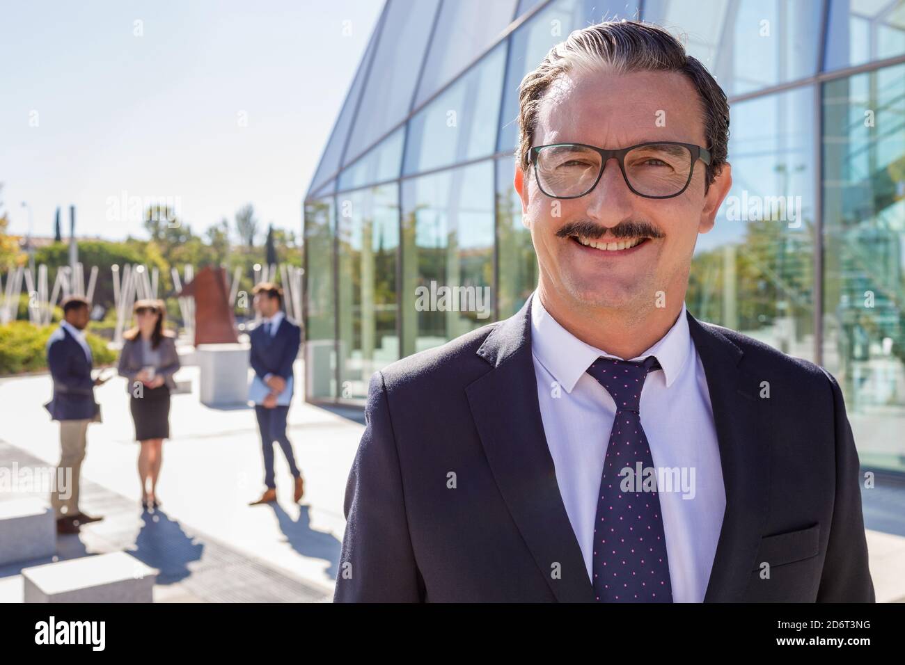 Happy middle aged male manager with mustache in classy outfit looking ...