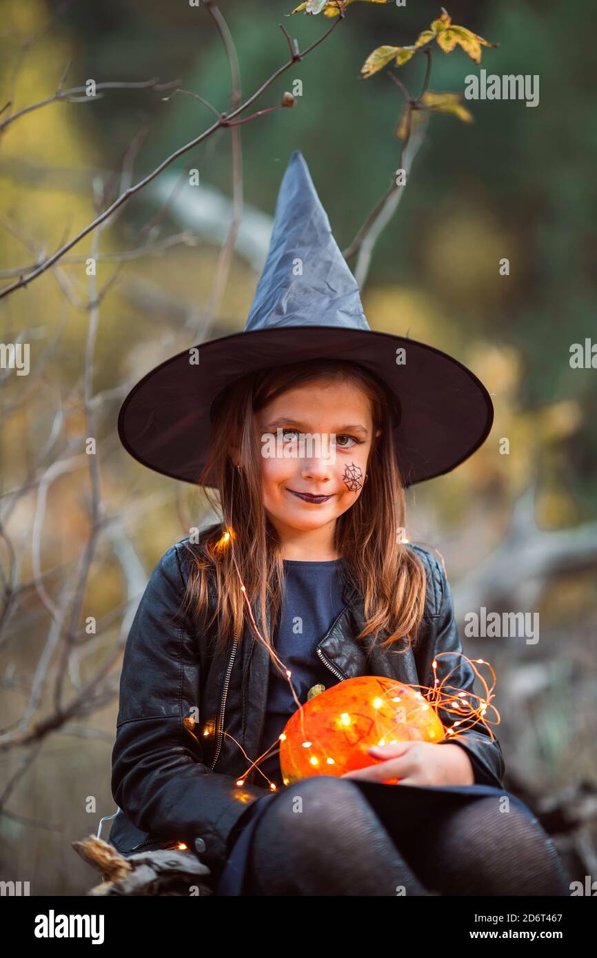 Cute girl in a Halloween costume holding a flashlight Stock Photo - Alamy
