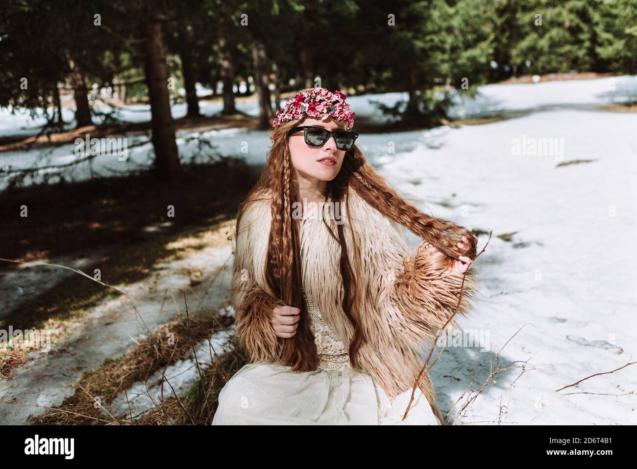 Attractive young long haired female in fur jacket and sunglasses with ...