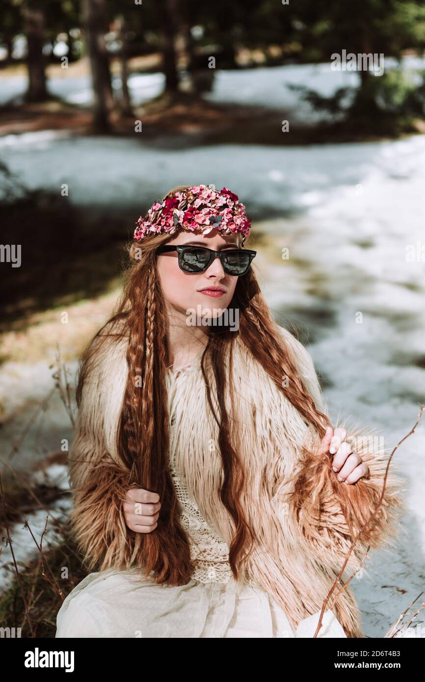 Attractive young long haired female in fur jacket and sunglasses with ...