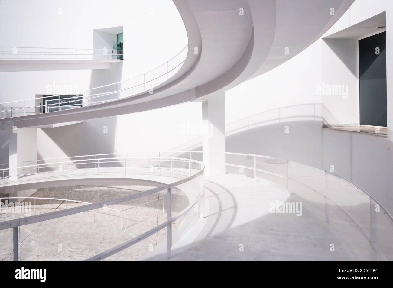 White smooth ramps or inclines with railings located outside modern ...