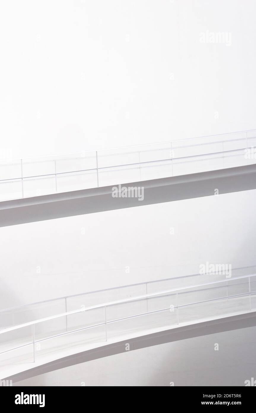 White smooth ramps or inclines with railings located outside modern ...