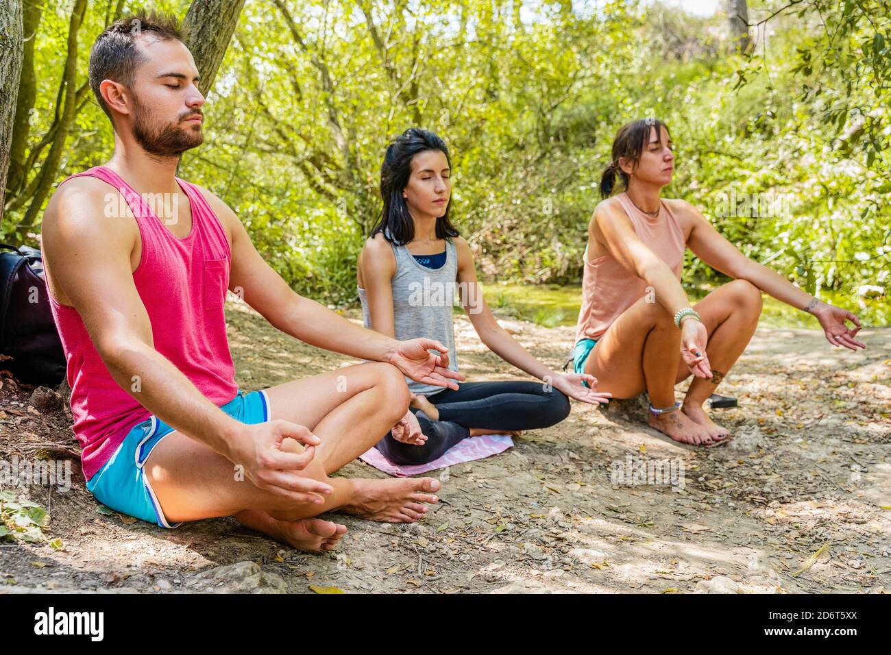 Group of reflective people with closed eyes sitting in Lotus pose while ...