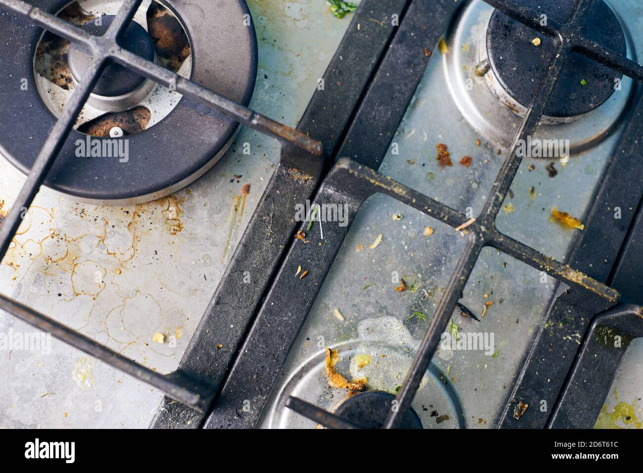 Dirty gas stove top with food leftovers. Unclean steel kitchen cooktop ...