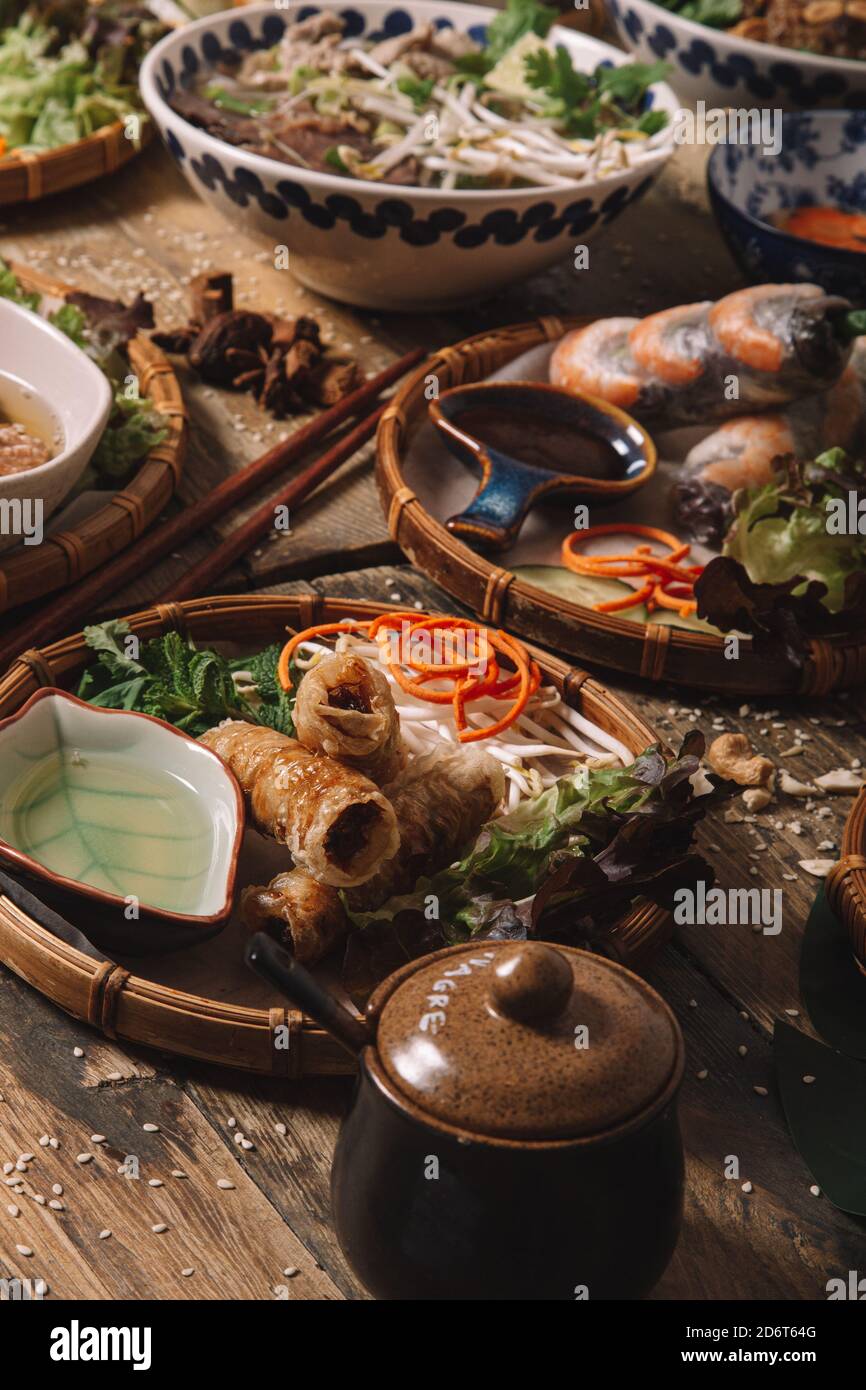 From above of assorted dishes of Vietnamese cuisine arranged on wooden ...