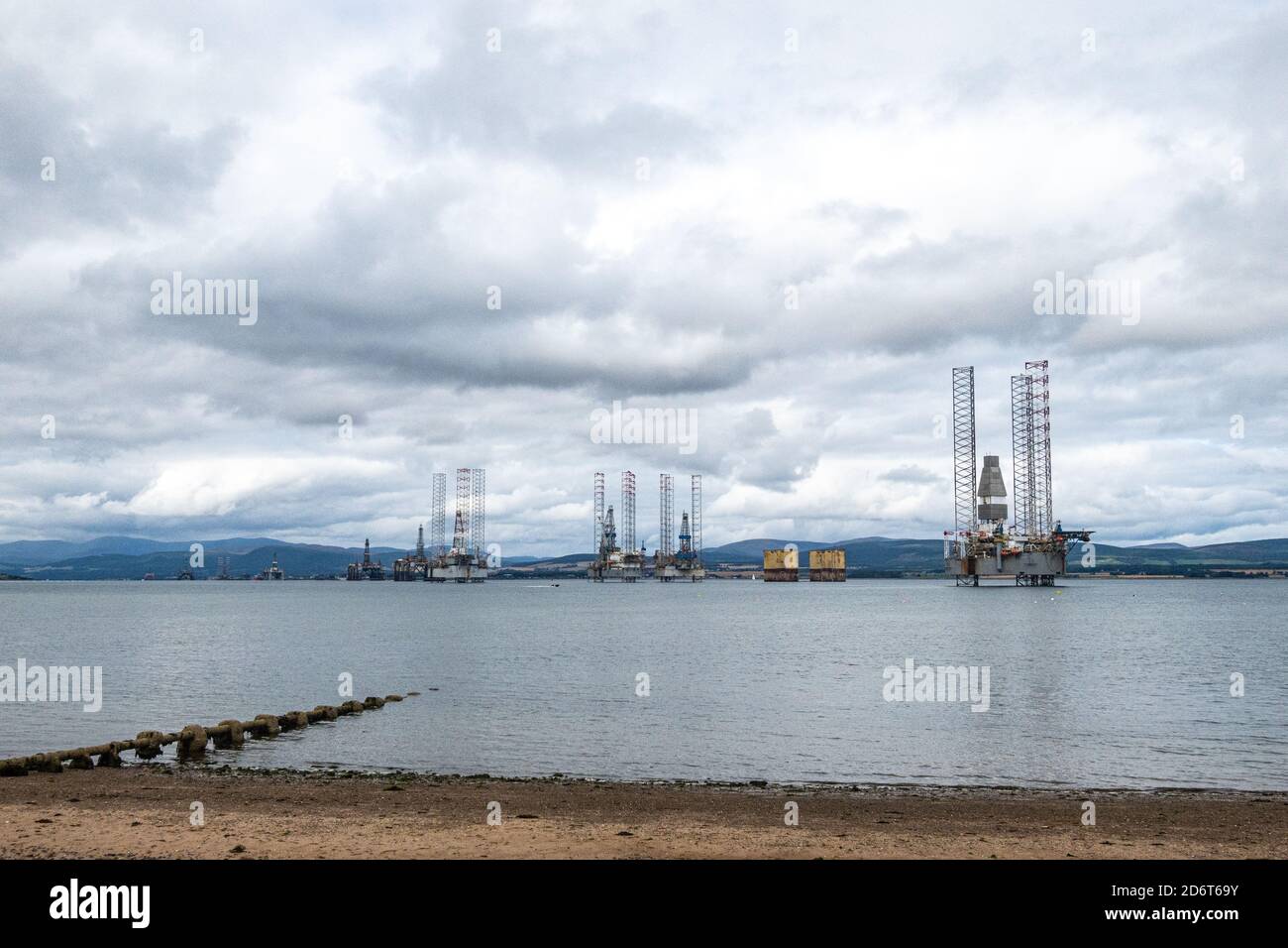 Moored oil rigs off the village of Cromarty on the Cromarty Firth, Ross ...